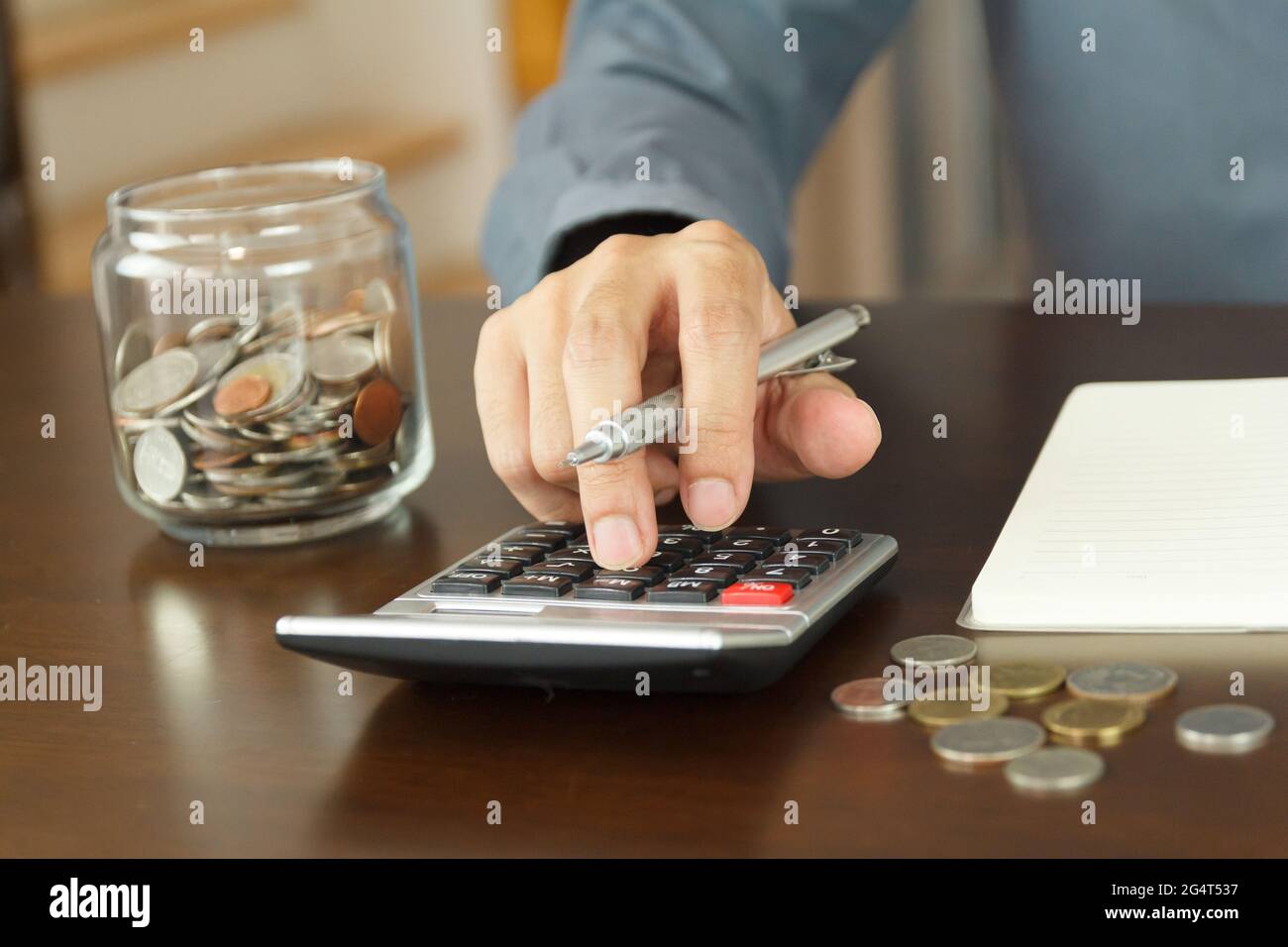 Money management concept. Hand man use calculator to calculate the ...