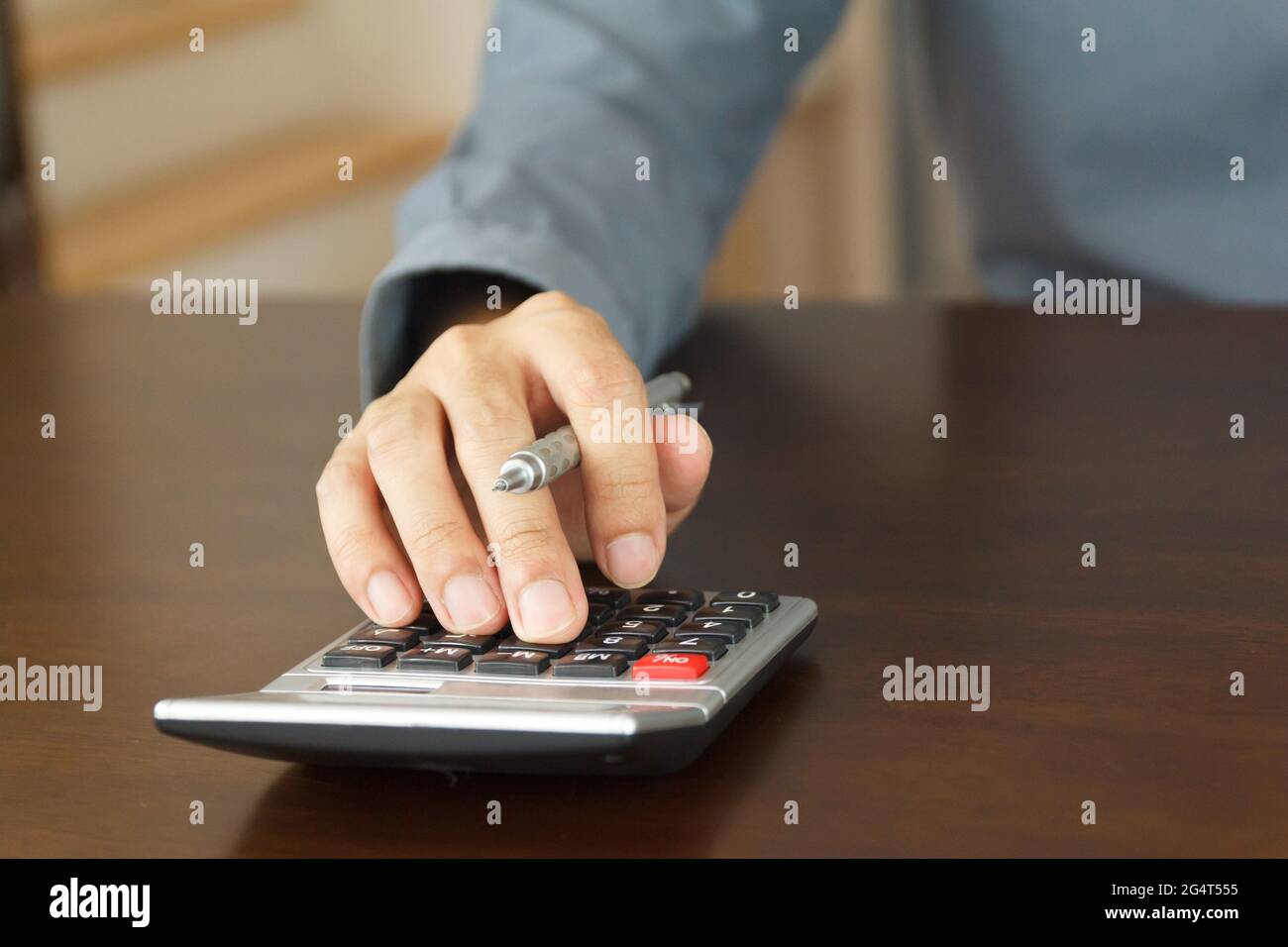 Close up hand man use calculator to calculate something Stock Photo - Alamy
