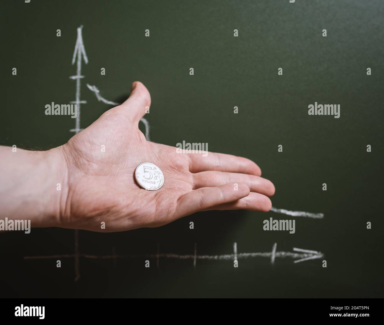 Chart with negative arrow and coin Stock Photo - Alamy