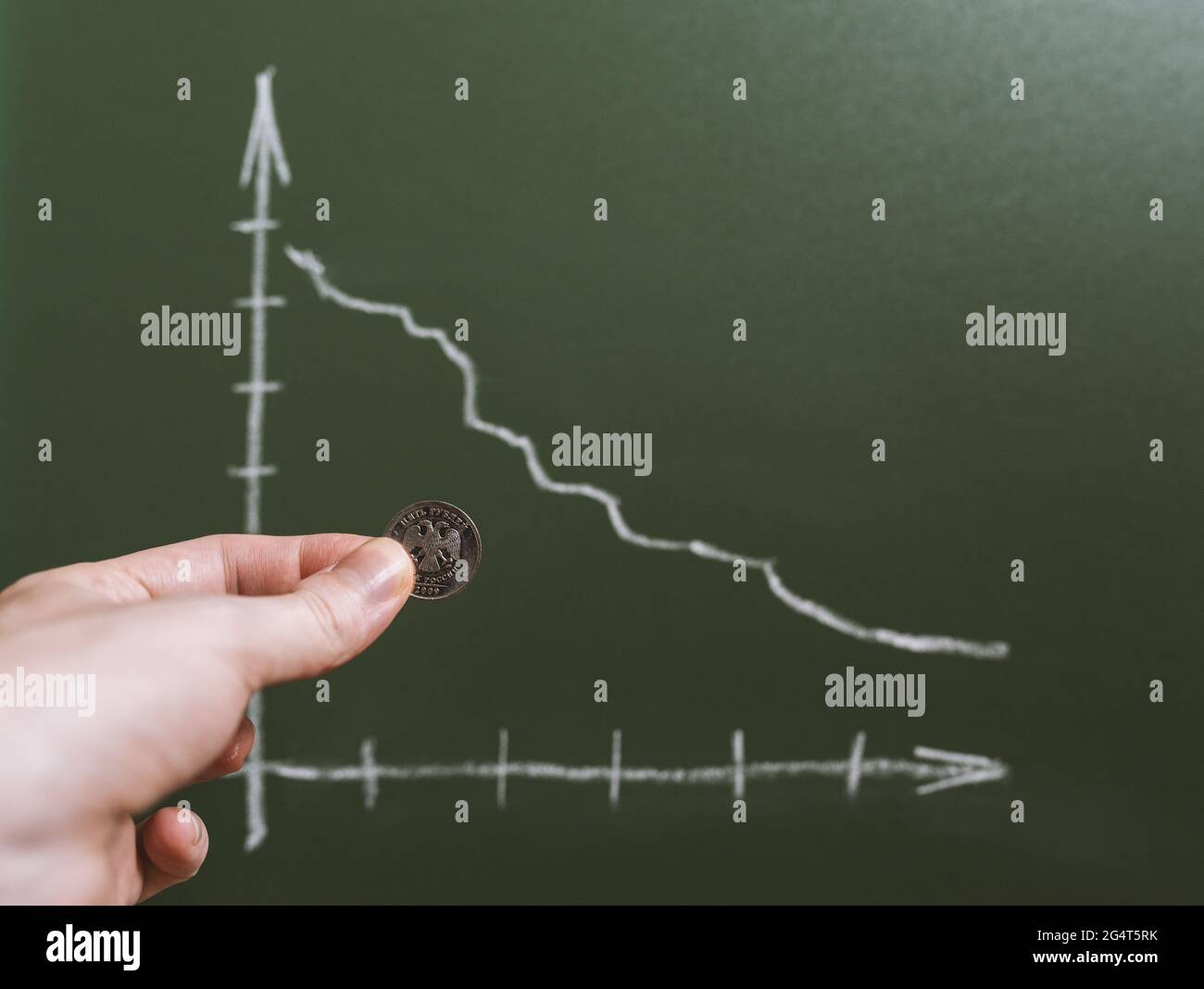 Chart with negative arrow and coin Stock Photo - Alamy