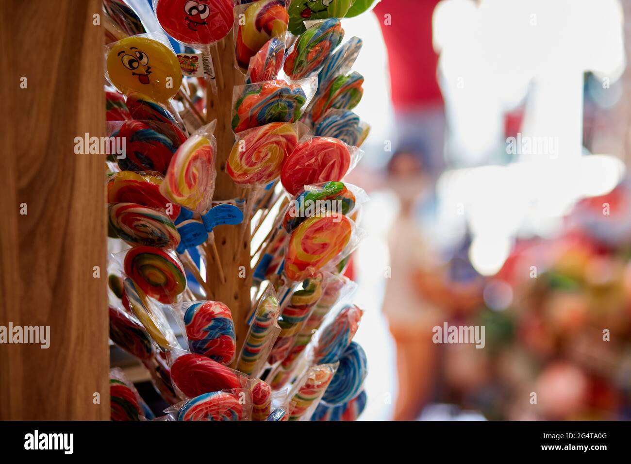 Assorted colored lollipops. Blurred background. Bright sunny background ...