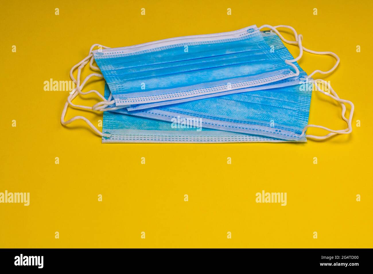 Closeup shot of medical hygienic face masks on a yellow surface Stock ...