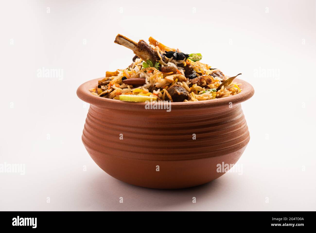 Dum Handi Mutton Biryani or gosht pilaf is prepared in an earthen or ...