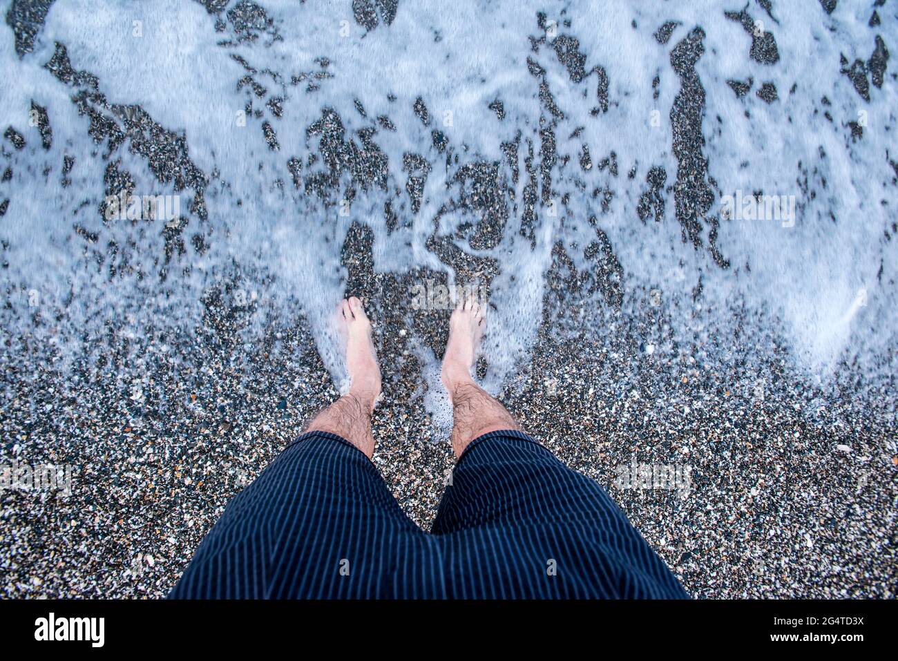 Adult man cooling off on the beach Stock Photo - Alamy