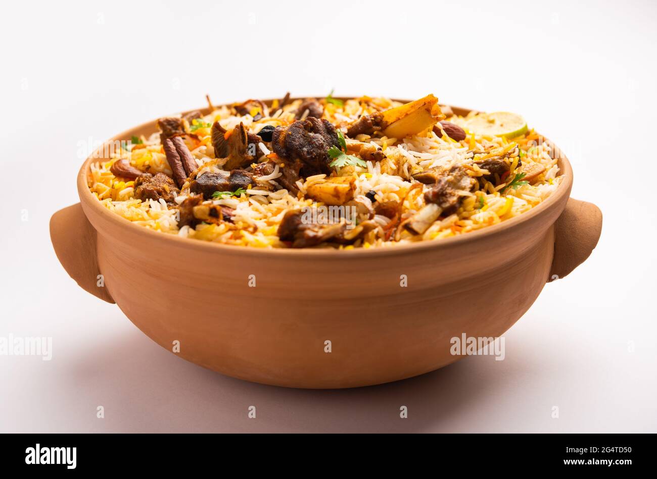 Dum Handi Mutton Biryani or gosht pilaf is prepared in an earthen or ...