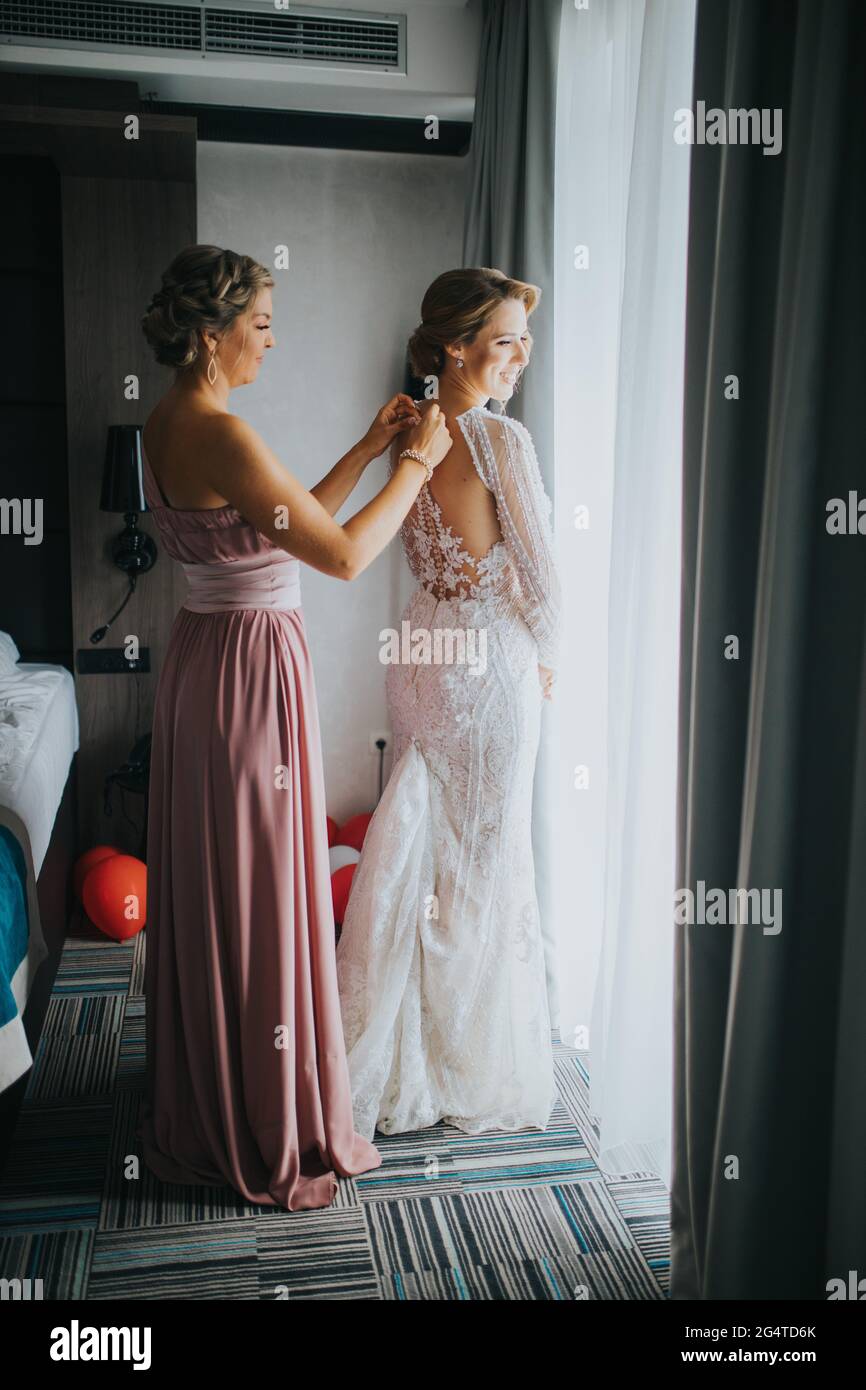 Bride getting dressed and preparing for the wedding Stock Photo - Alamy