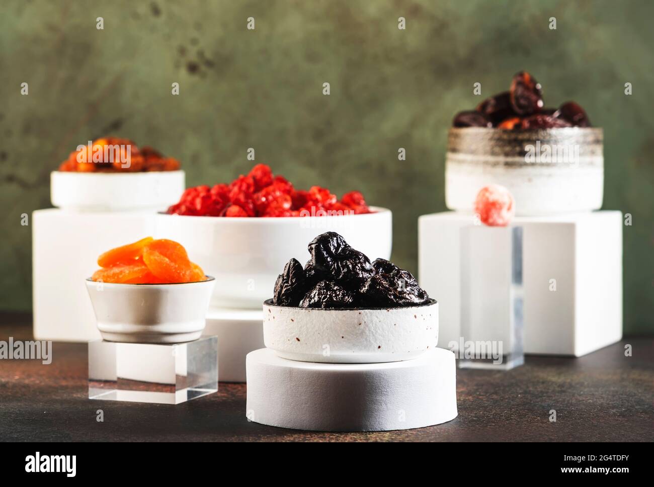 Healthy food snacks: natural dried fruits in bowls on rusty green ...