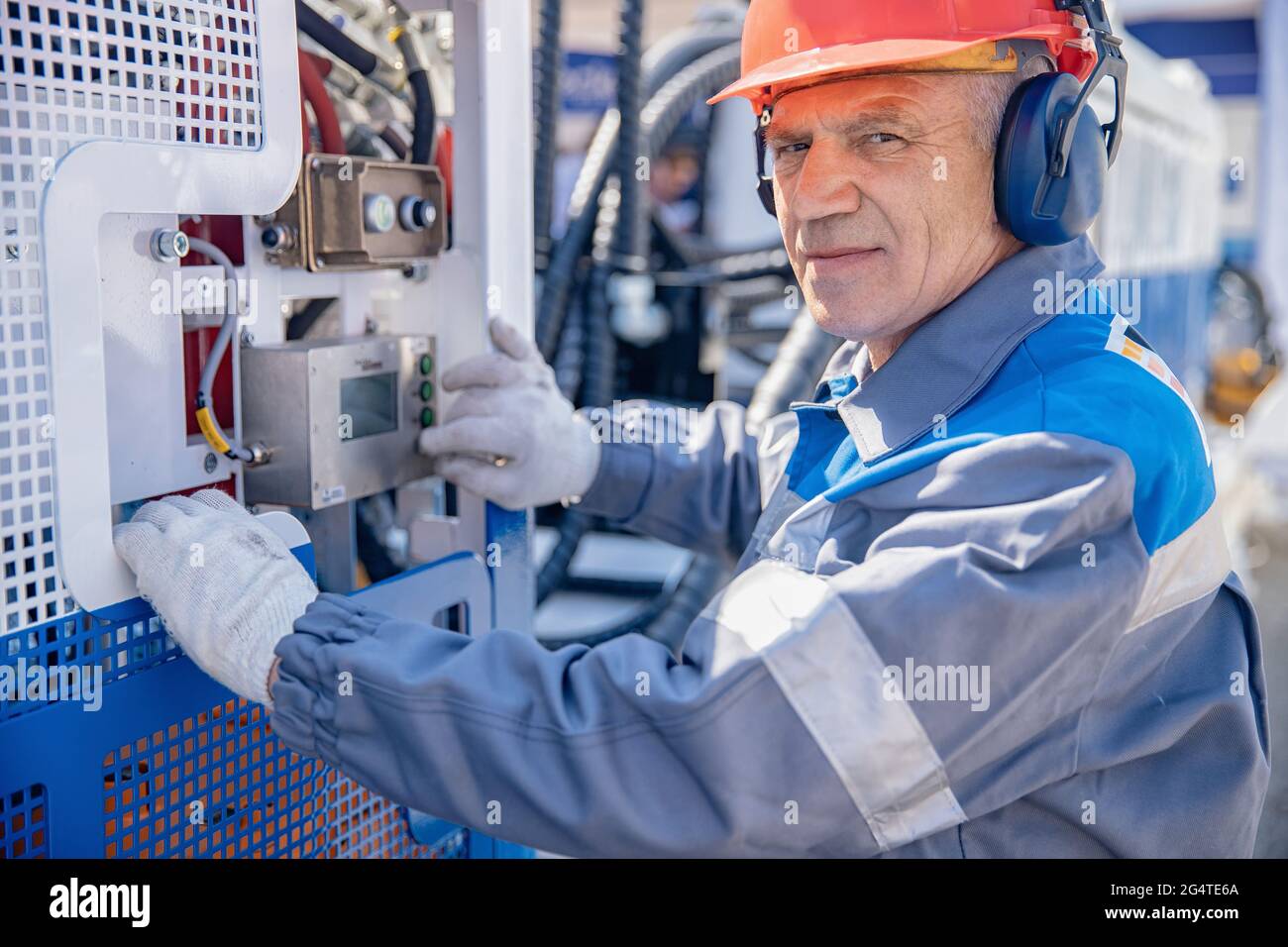 Industrial portrait electrician worker man at factory in hard hat and ...