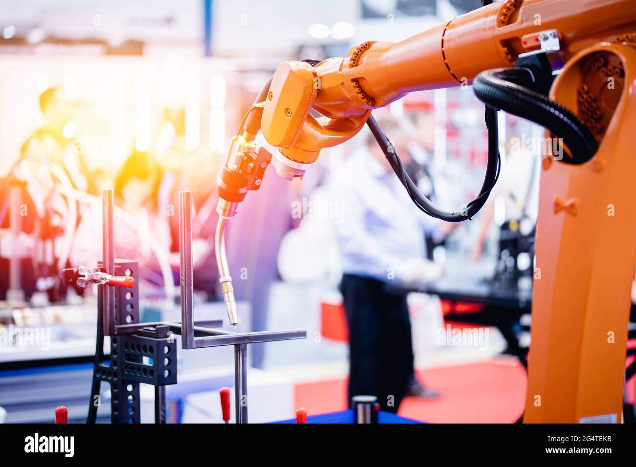 Process robot hand performs welding work on metal structures industrial ...