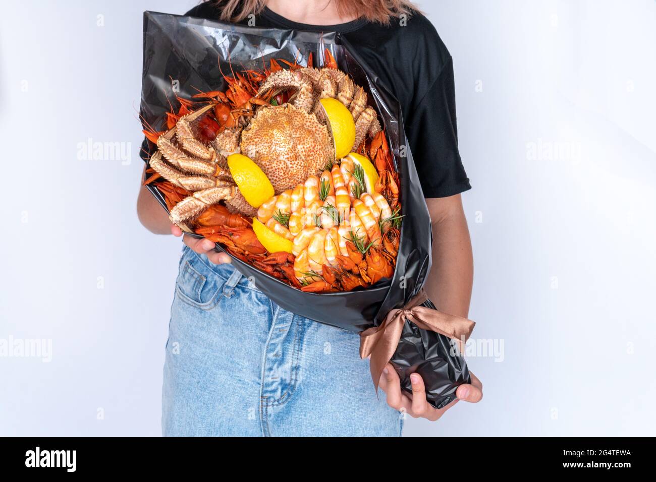 Creative edible Food bouquet in the hands of a girl on white background ...