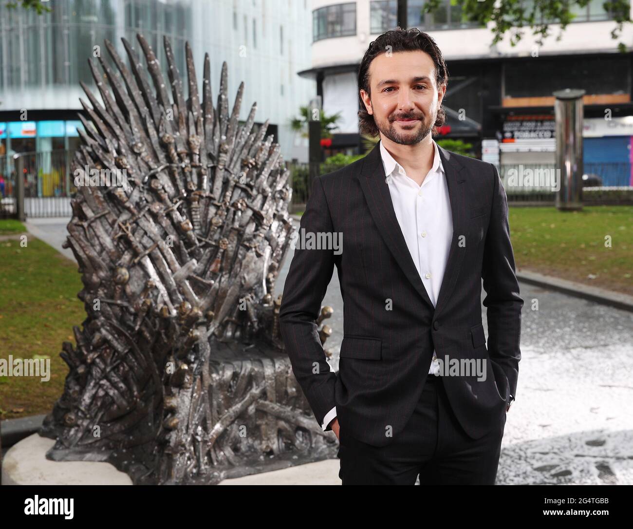 London, UK. Alex Zane with The Game of Thrones chair as seen in the HBO ...