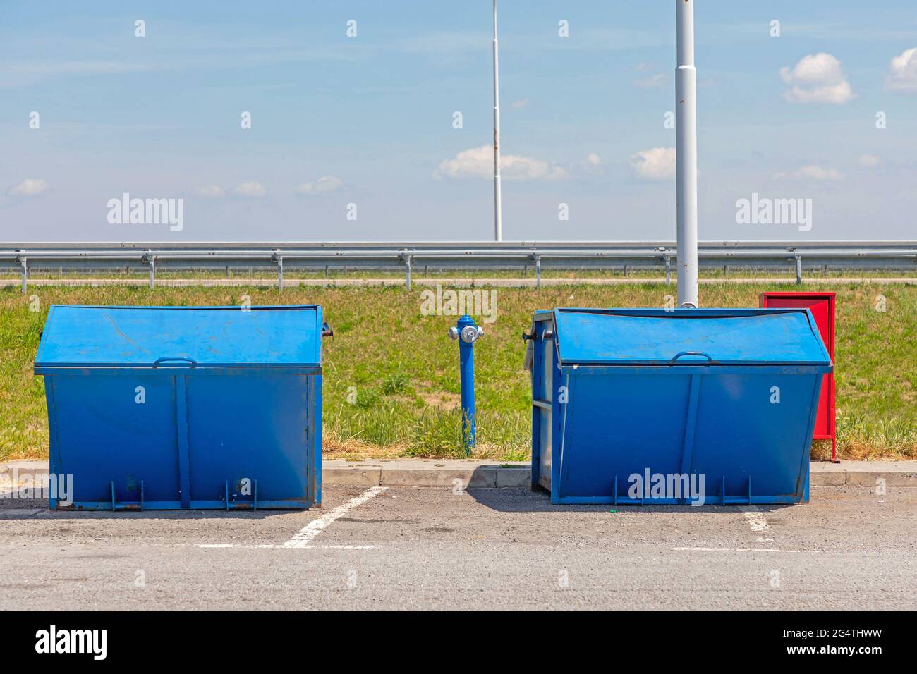 Two Big Blue Trash Dumpster Containers at Highway Stop Stock Photo - Alamy