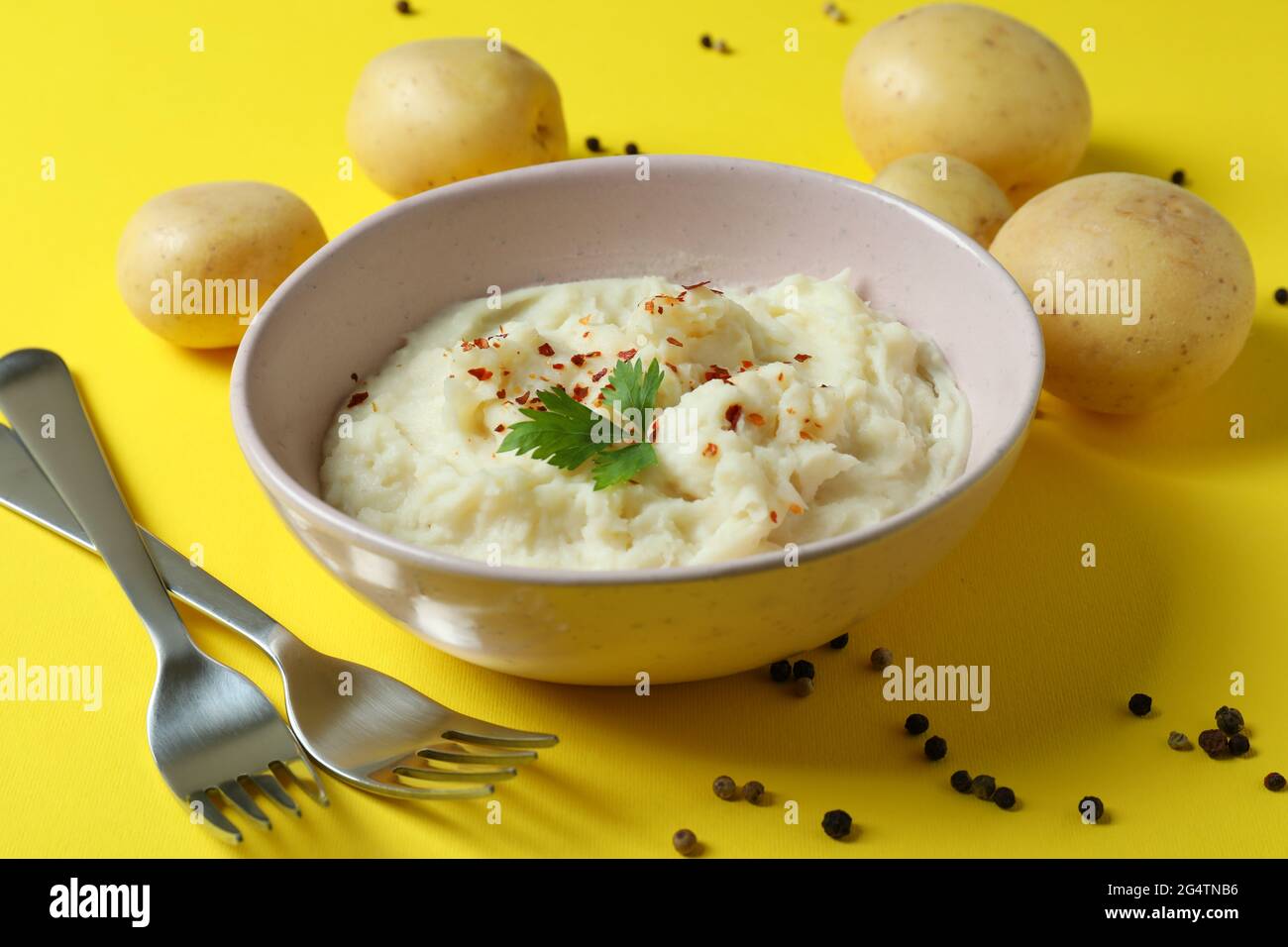 Plate of mashed potatoes and ingredients on yellow background Stock ...