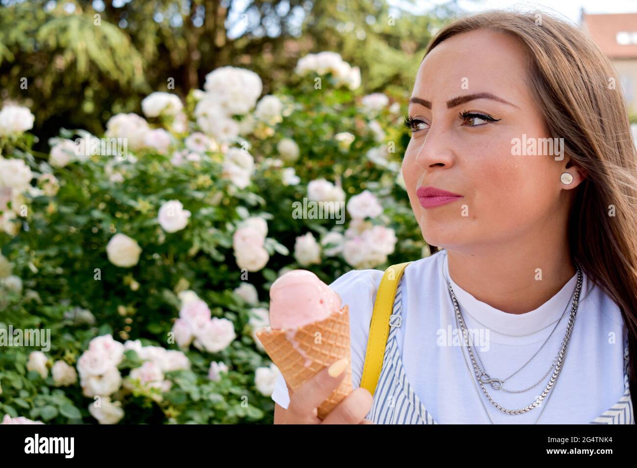 Woman eating ice cream, outdoors Stock Photo - Alamy