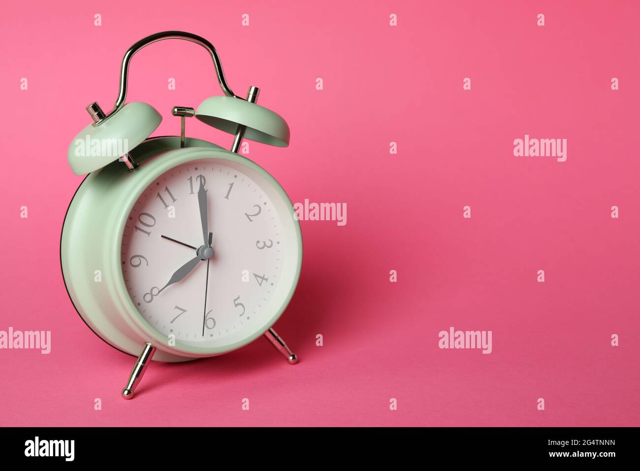 Stylish mint alarm clock on pink background Stock Photo - Alamy