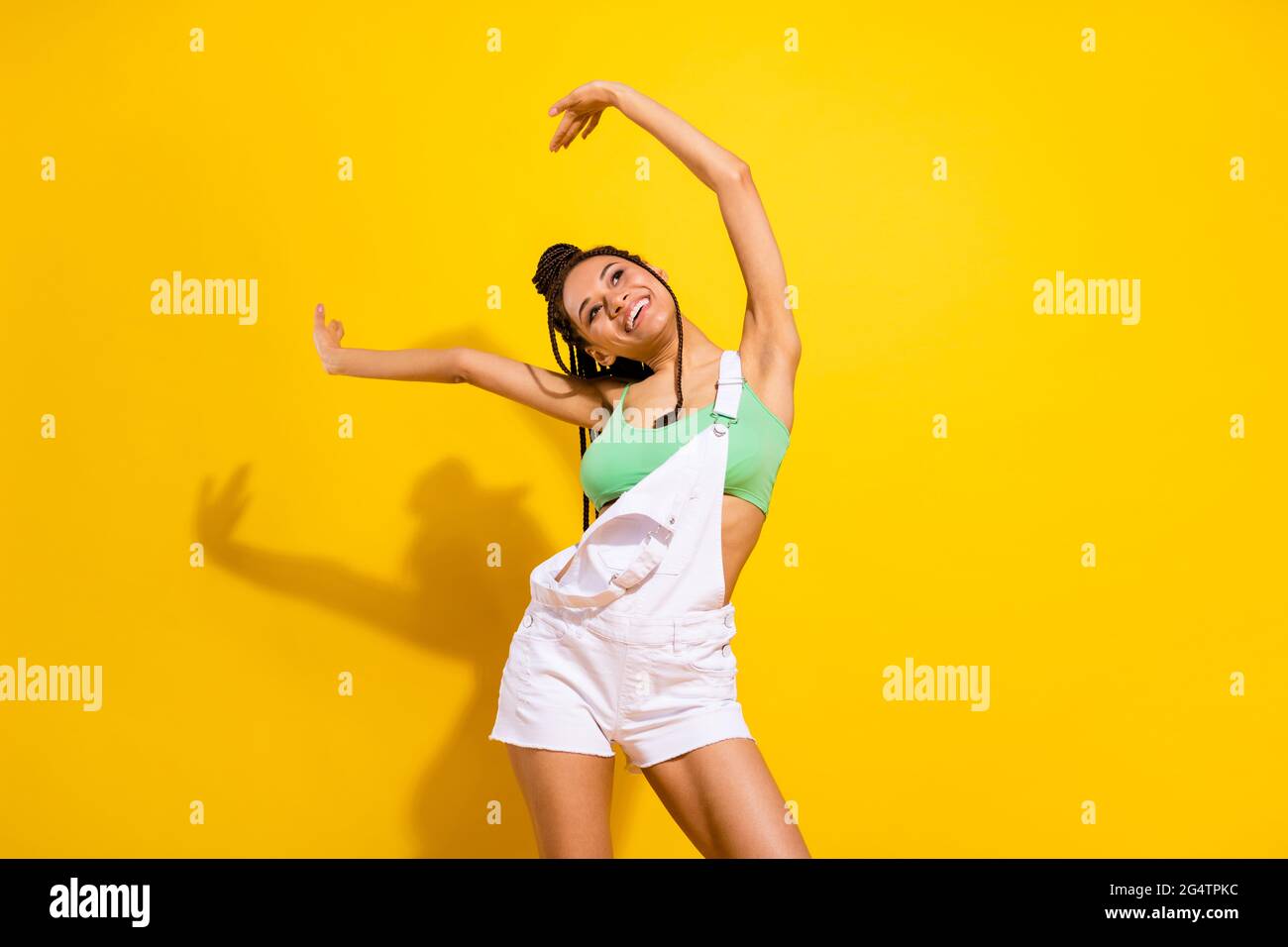 Photo of joyful nice young dark skin woman look empty space dance raise ...