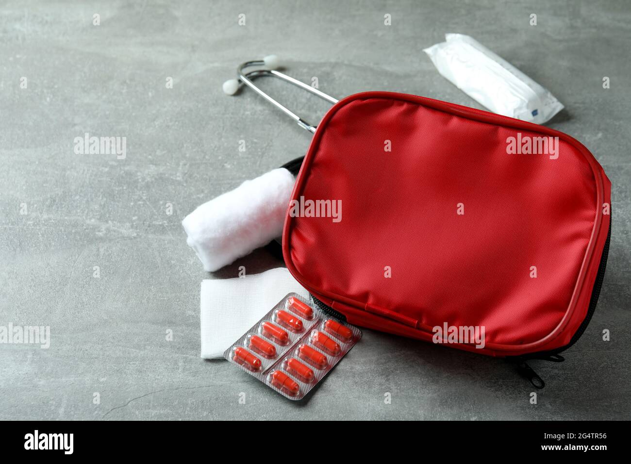 First aid medical kit on gray textured table Stock Photo - Alamy