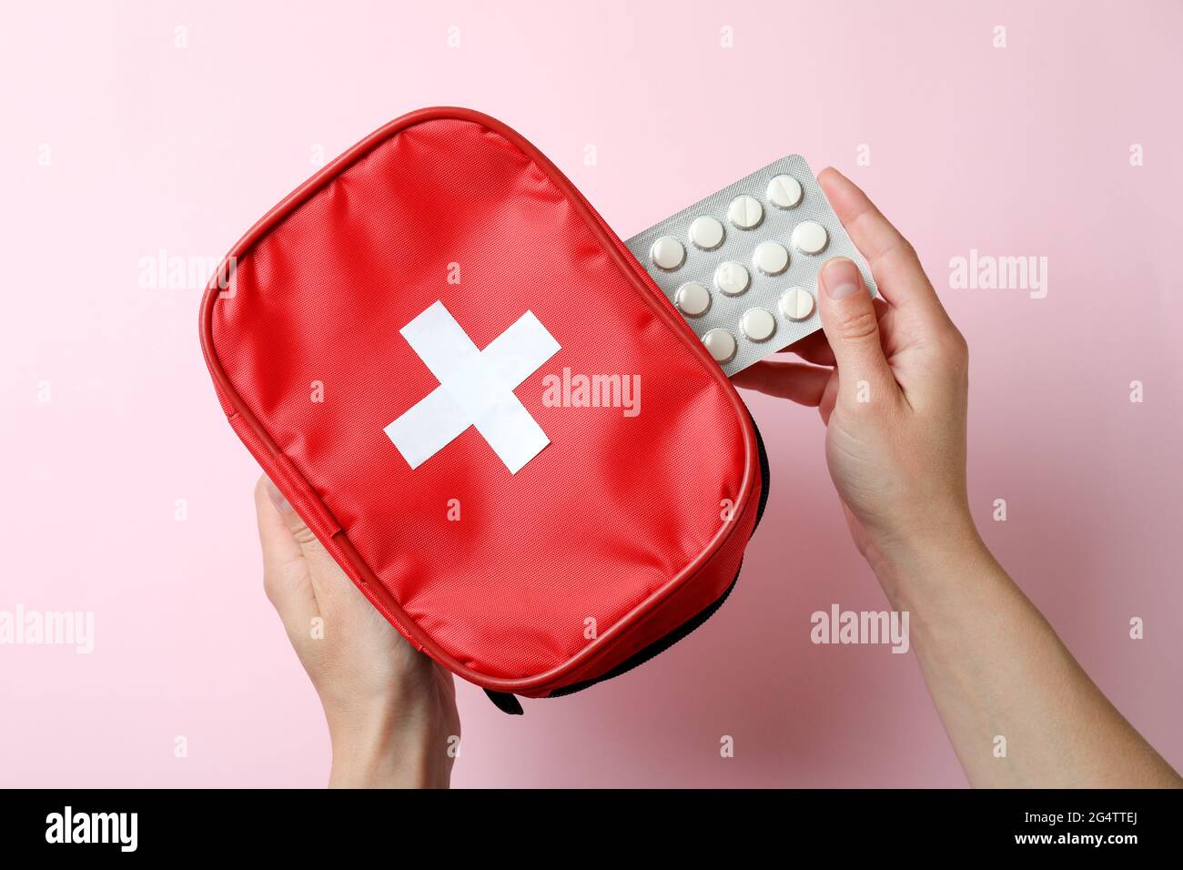 Female hands hold first aid medical kit on pink background Stock Photo ...