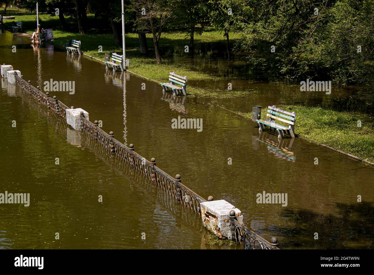 Public park drenched in rain. Water logged park.Wet benches. Park ...