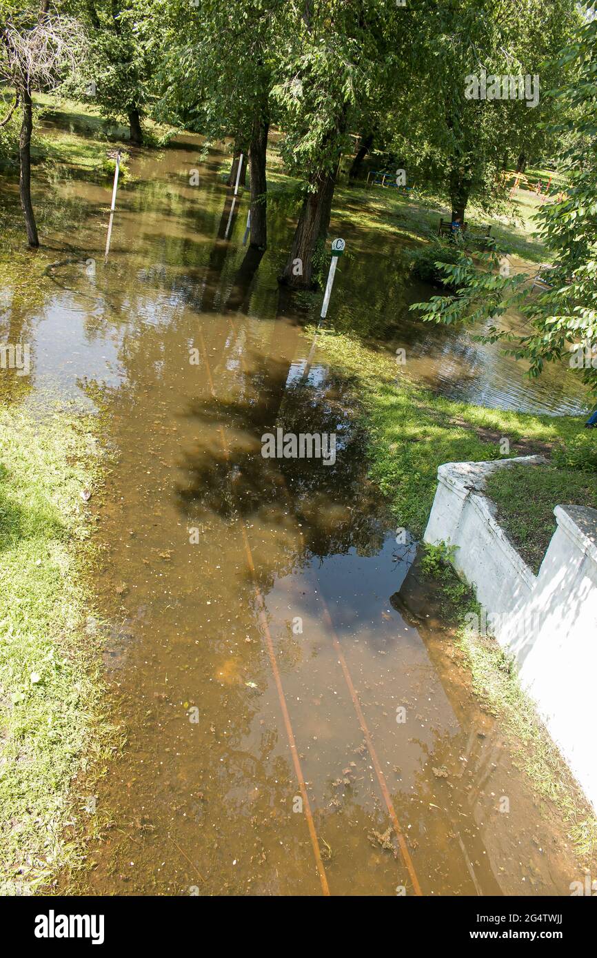 Public park drenched in rain. Water logged park.Wet benches. Park ...