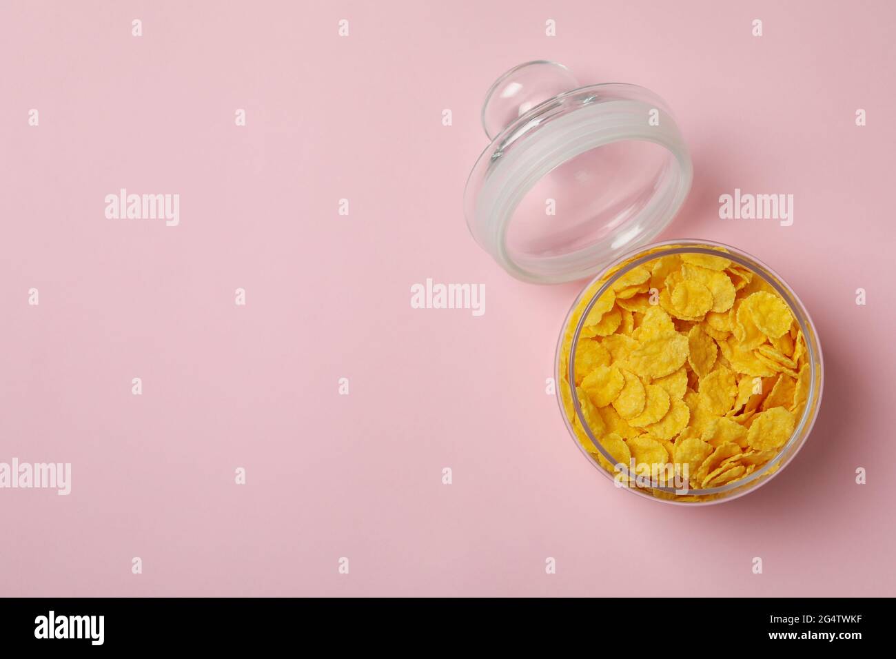 Jar of corn flakes on pink background Stock Photo - Alamy