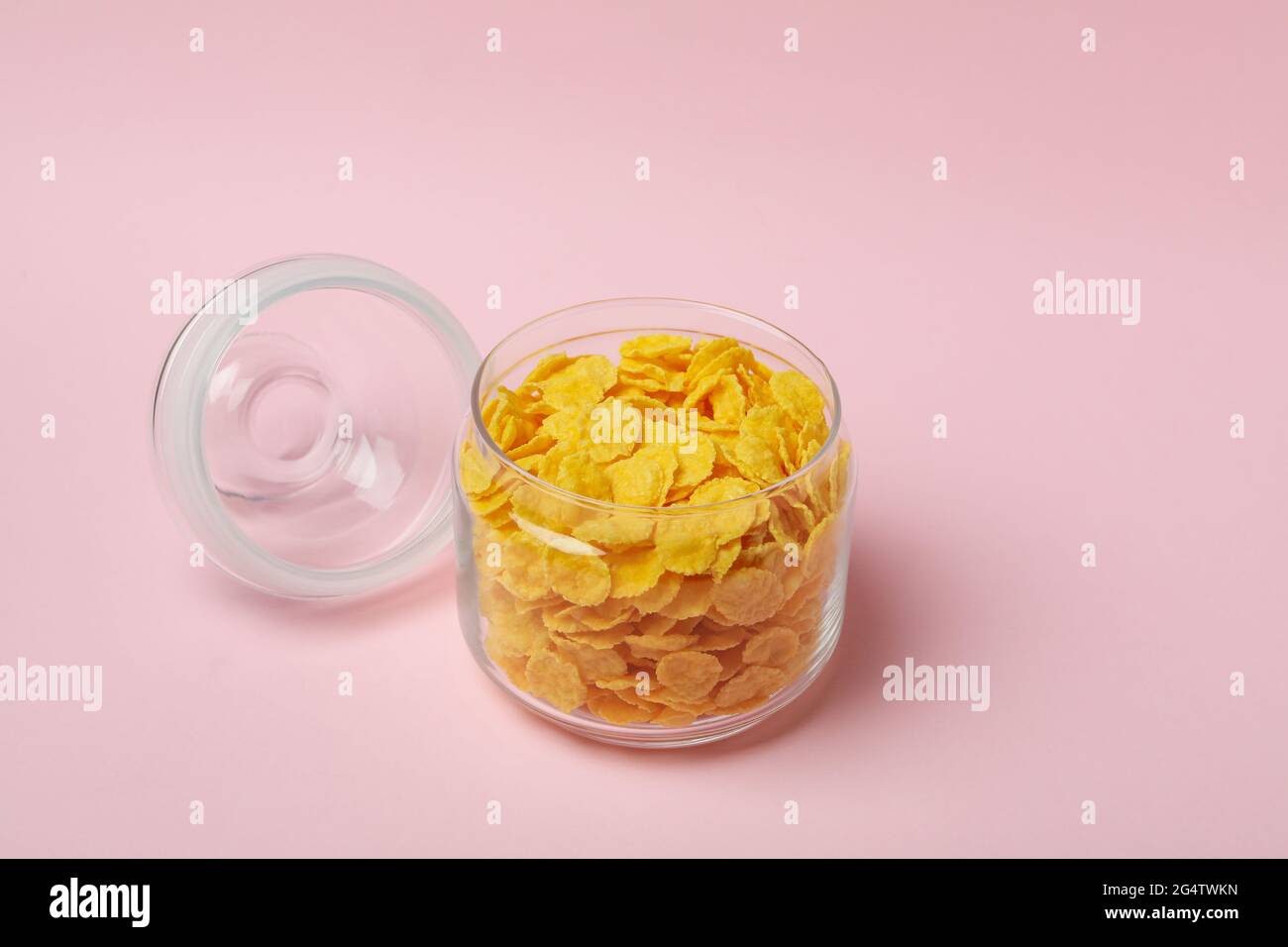 Jar of corn flakes on pink background Stock Photo - Alamy