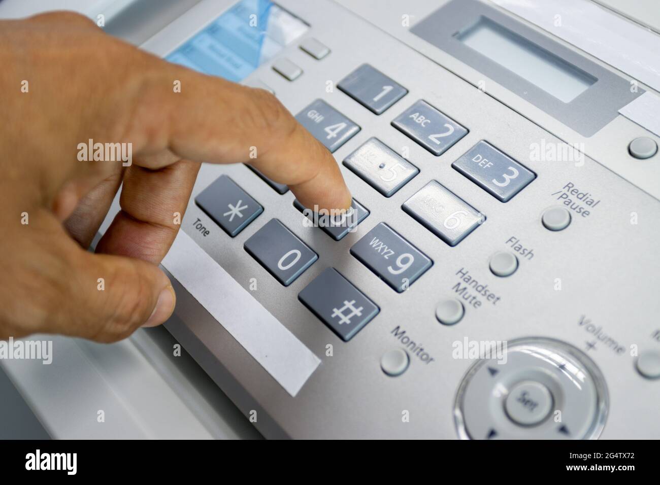 hand man are using a fax machine in the office, equipment for data ...