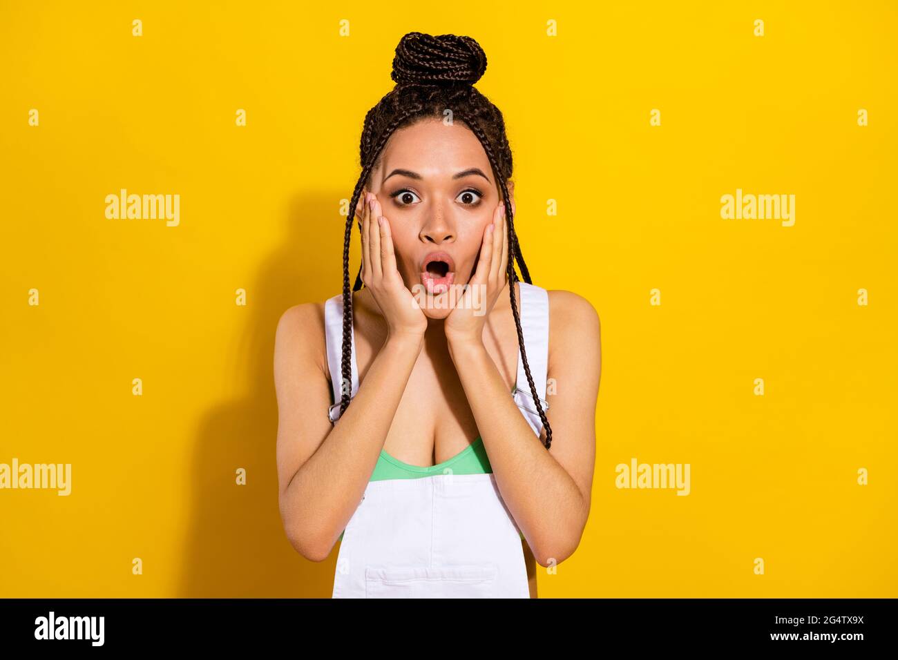 Photo of impressed funny dark skin lady wear green crop top arms cheeks ...