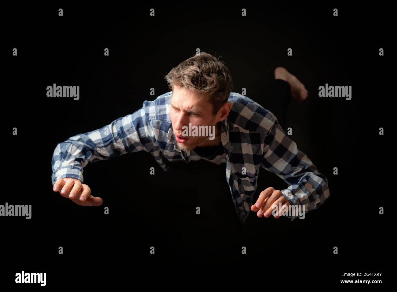 attractive scared male fall down from height on dark background Stock ...