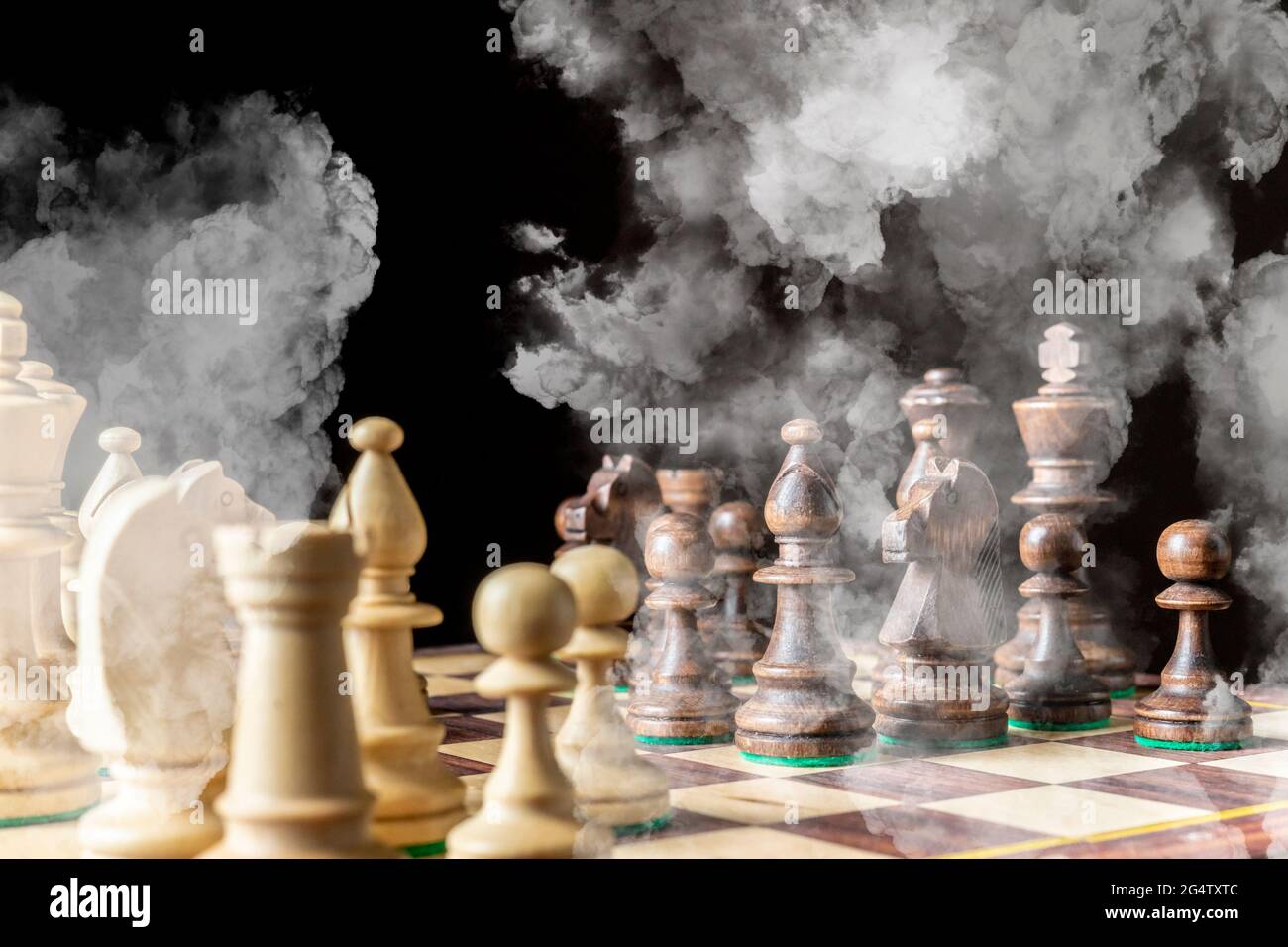 chess board game battle in smoke concept background Stock Photo - Alamy