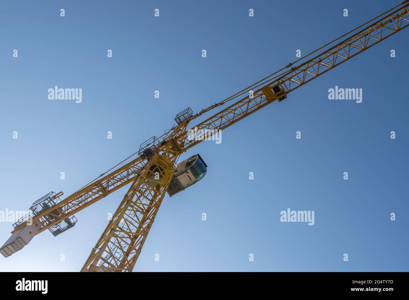 Tower crane on blue sky background Stock Photo - Alamy