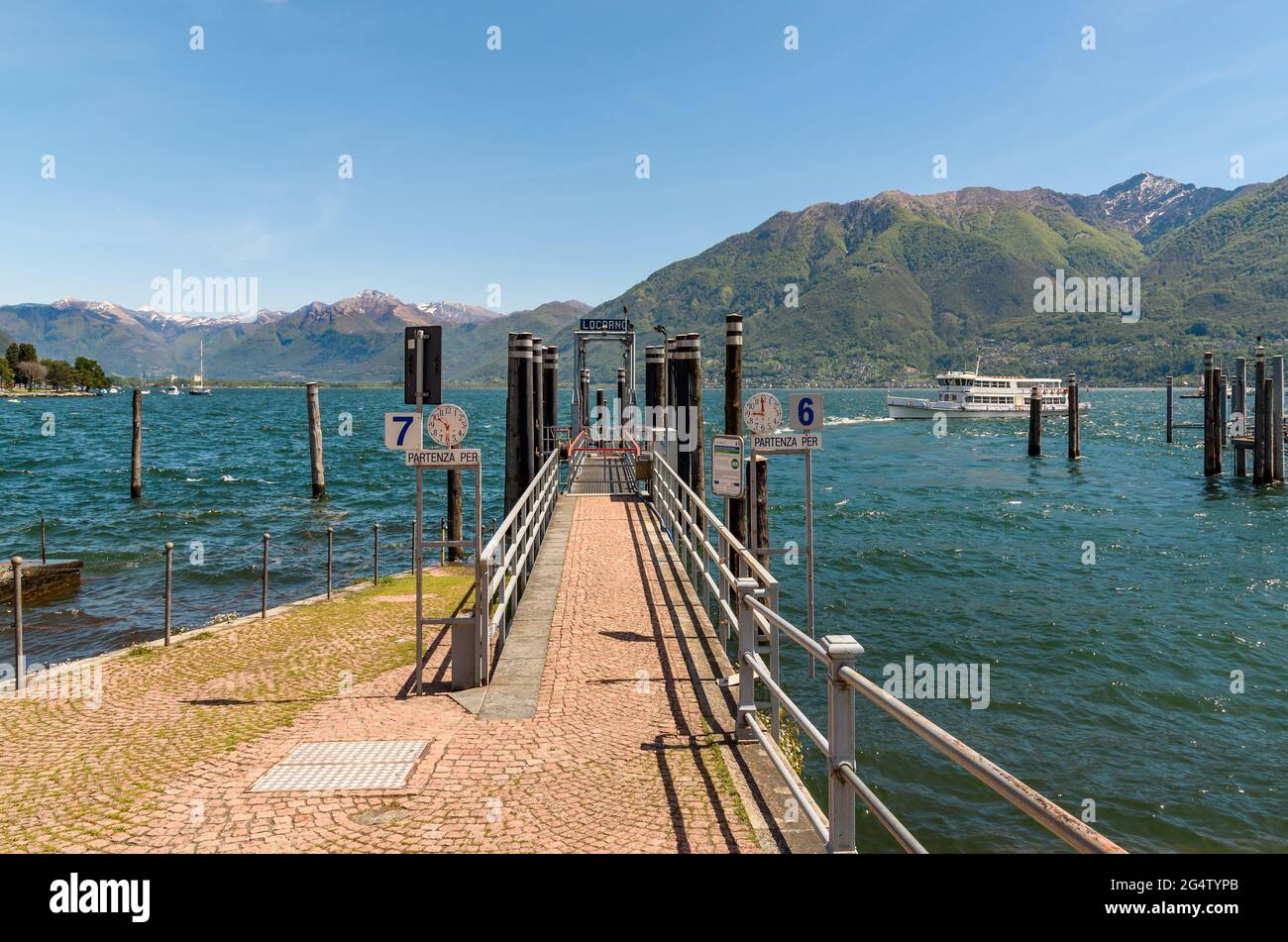 Ferry boat at the pier on the shore of lake Maggiore in Locarno, Ticino ...