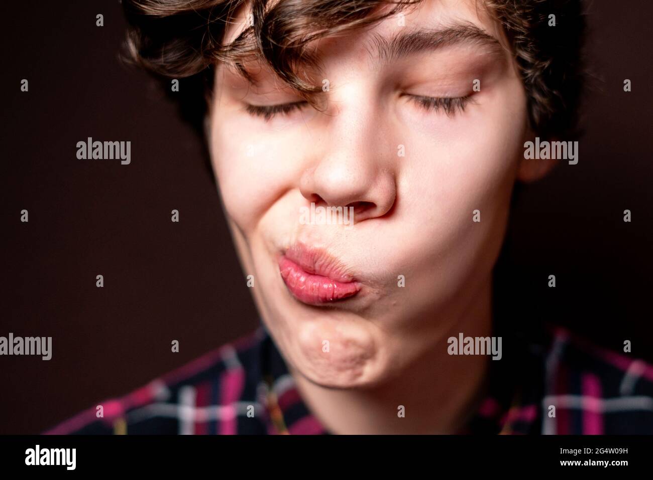 closeup photo of young man chew junk food on dark background Stock ...