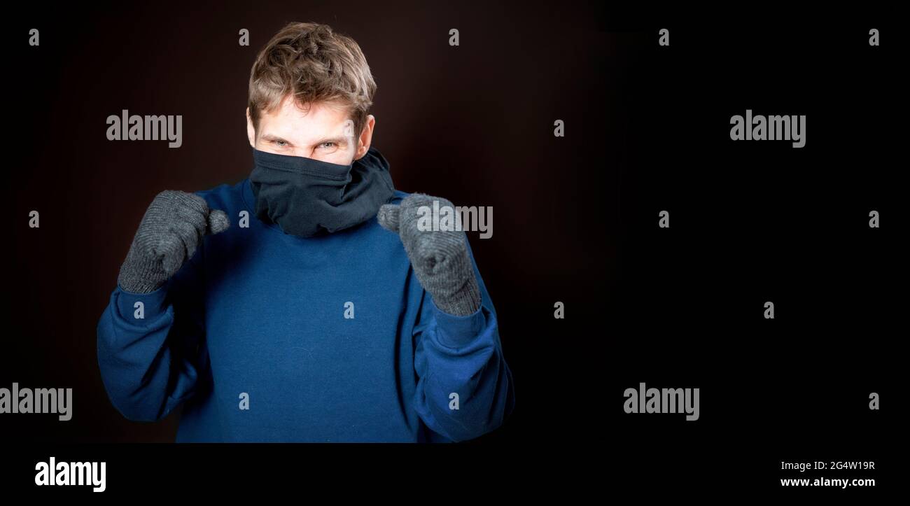 male gangster wear dark mask fight with fists on dark background ...