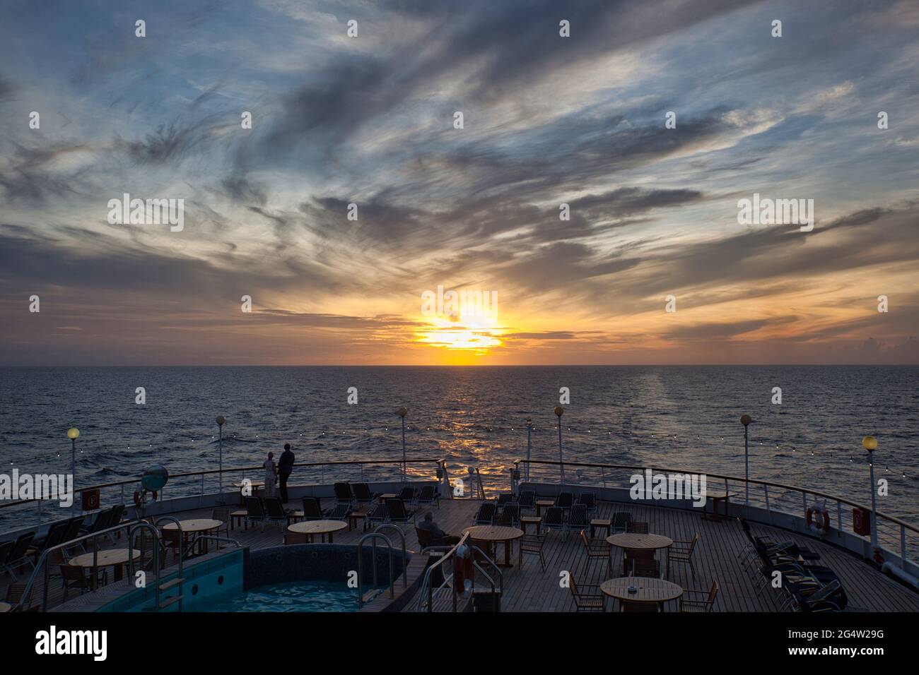 An Indian Ocean sunset from the stern of a cruise ship. A couple at the ...