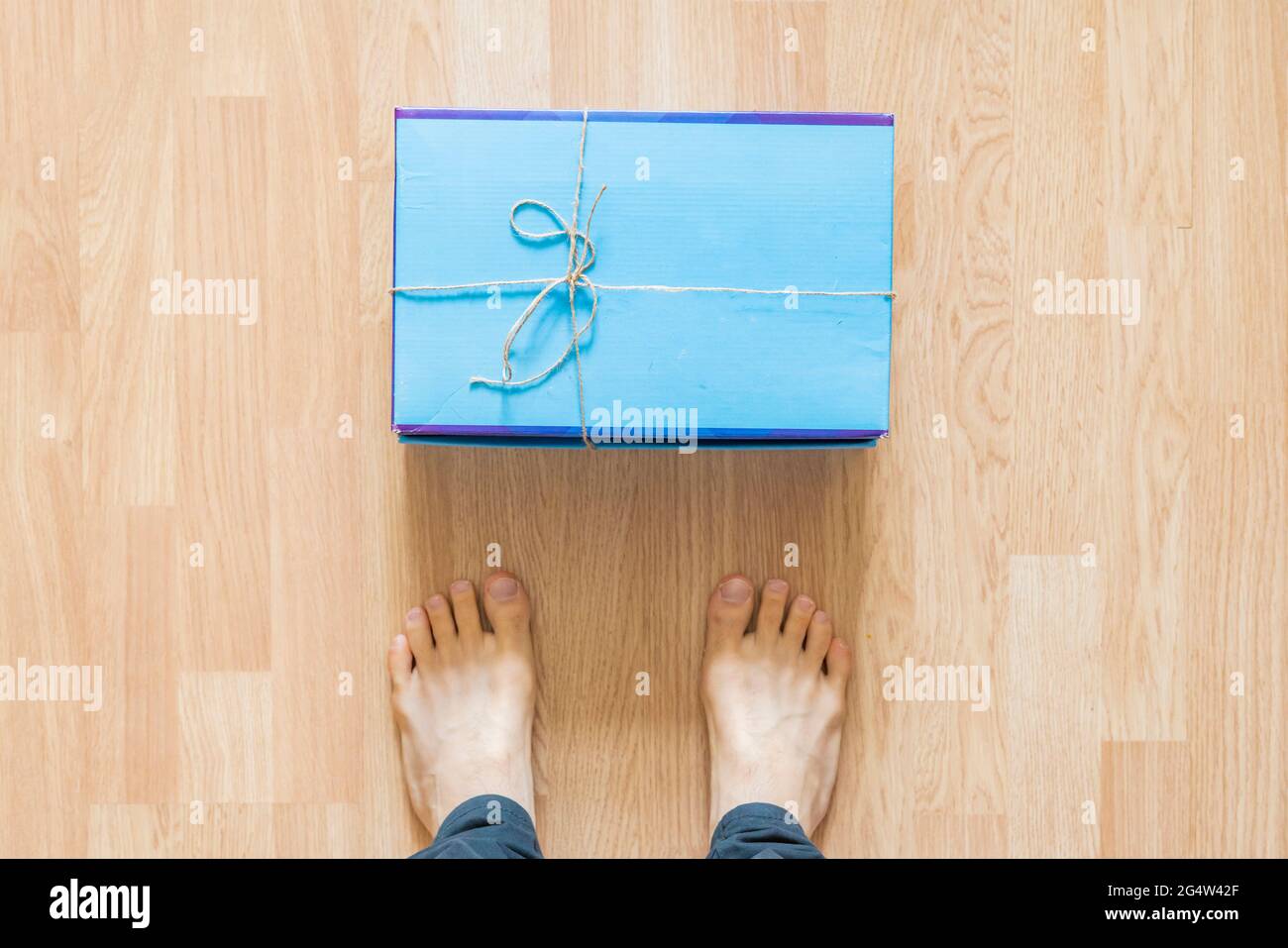 new delievered parcel lay in front of legs indoors on the floor Stock ...