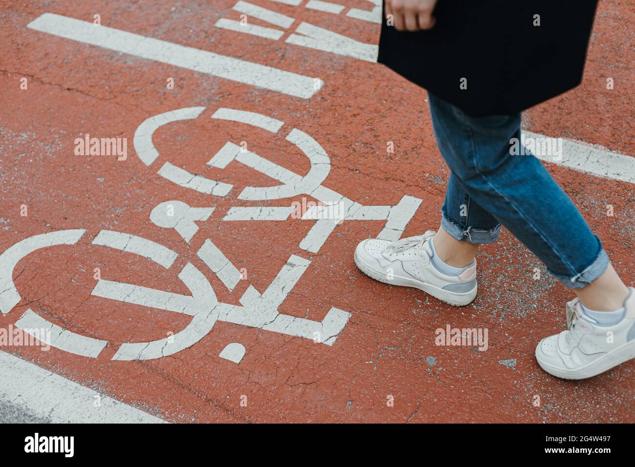 High angle shot of a female walking in a bike path Stock Photo - Alamy