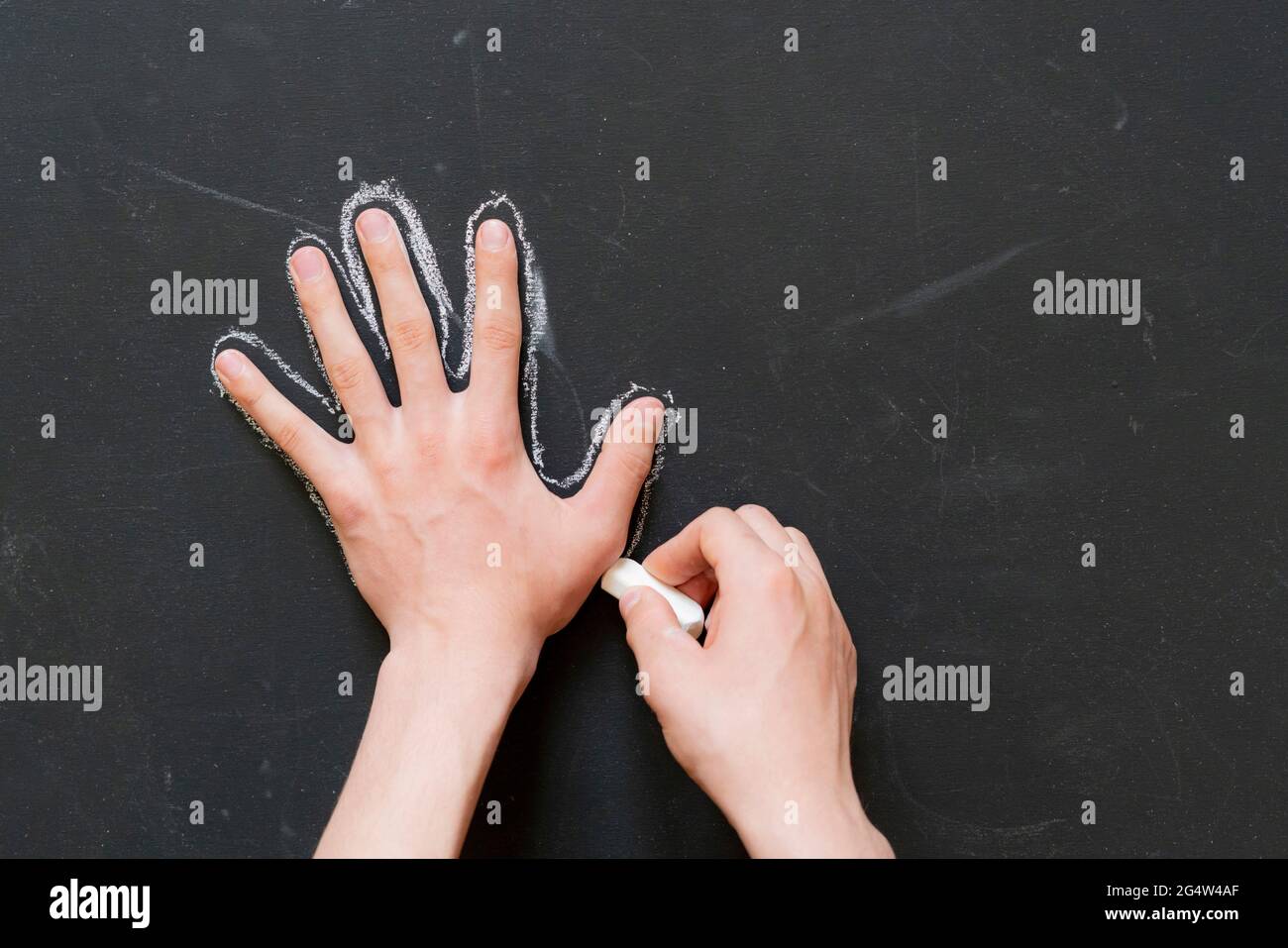 hand hold piece of chalk and draw a circuit of other hand Stock Photo ...