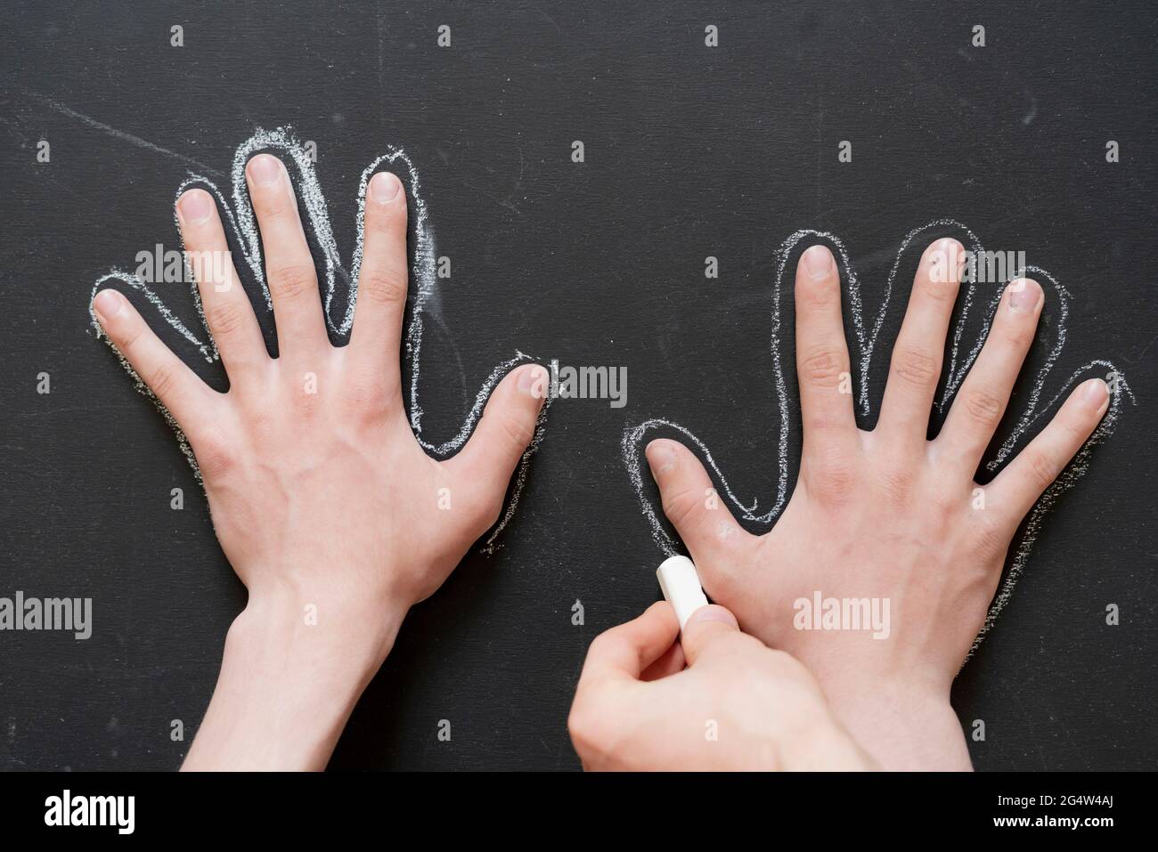 hand hold piece of chalk and draw a circuit of other hand Stock Photo ...
