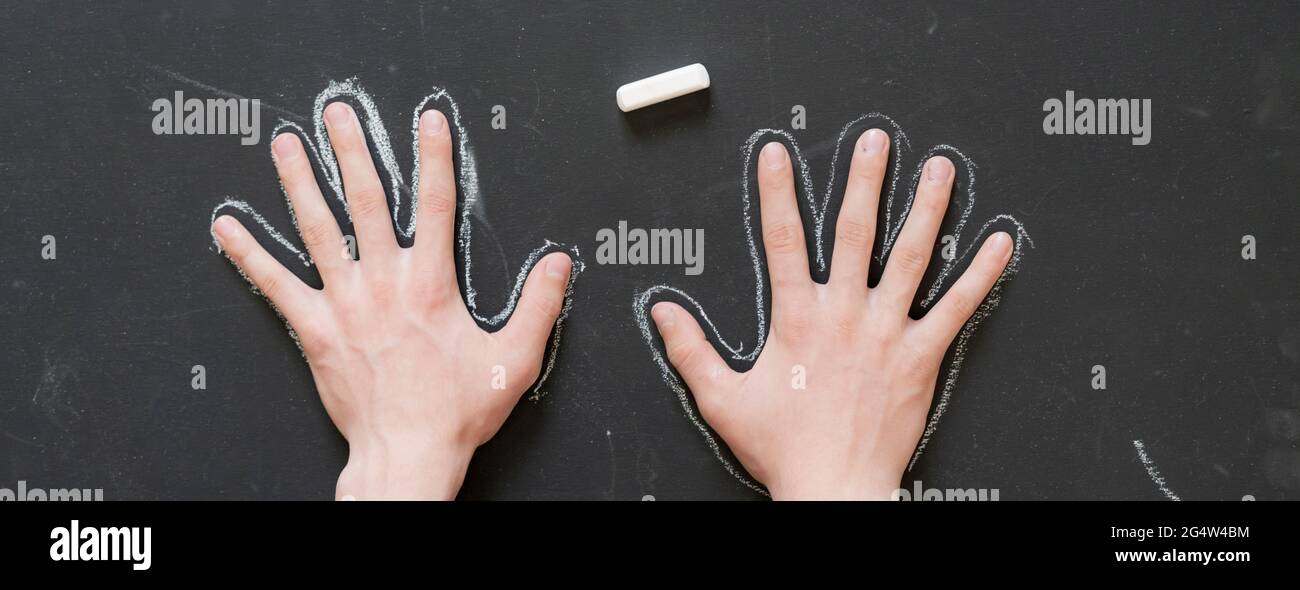hand hold piece of chalk and draw a circuit of other hand Stock Photo ...