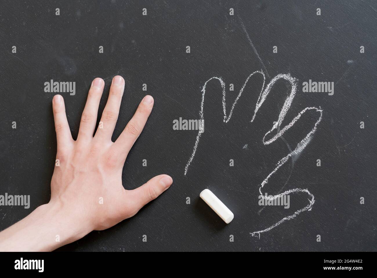 hand hold piece of chalk and draw a circuit of other hand Stock Photo ...