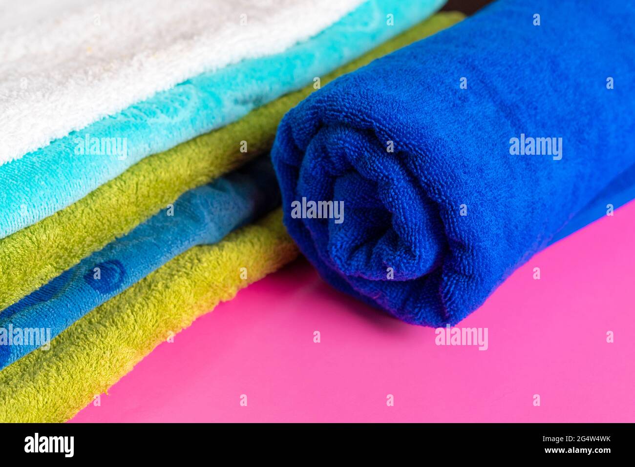 close up photo of rolled stack of colorful towels Stock Photo - Alamy