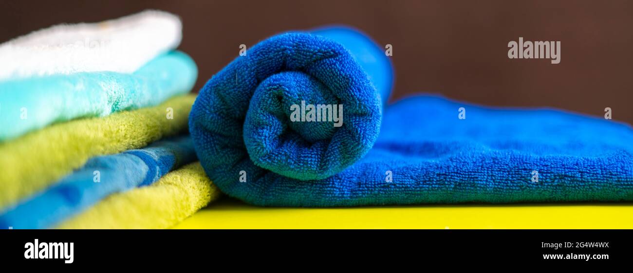 close up photo of rolled stack of colorful towels Stock Photo - Alamy