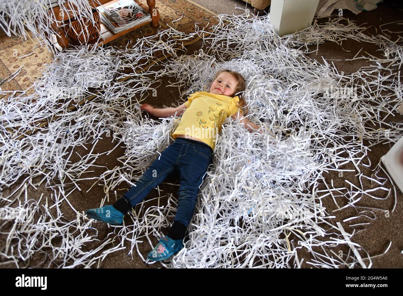 child playing in shredded paper Stock Photo - Alamy