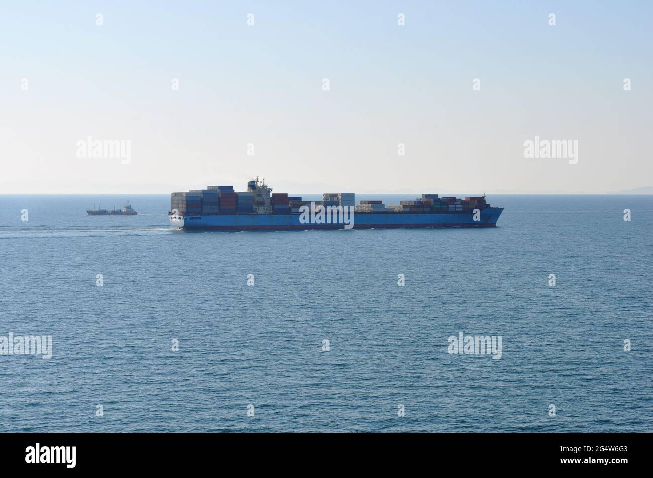A large merchant ship container vessel in coastal waters of ocean. A ...