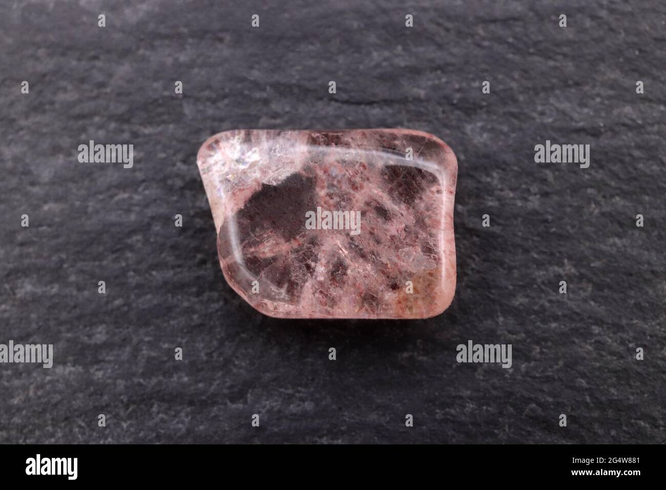 Strawberry quartz jewel stone texture on black stone background. Macro ...