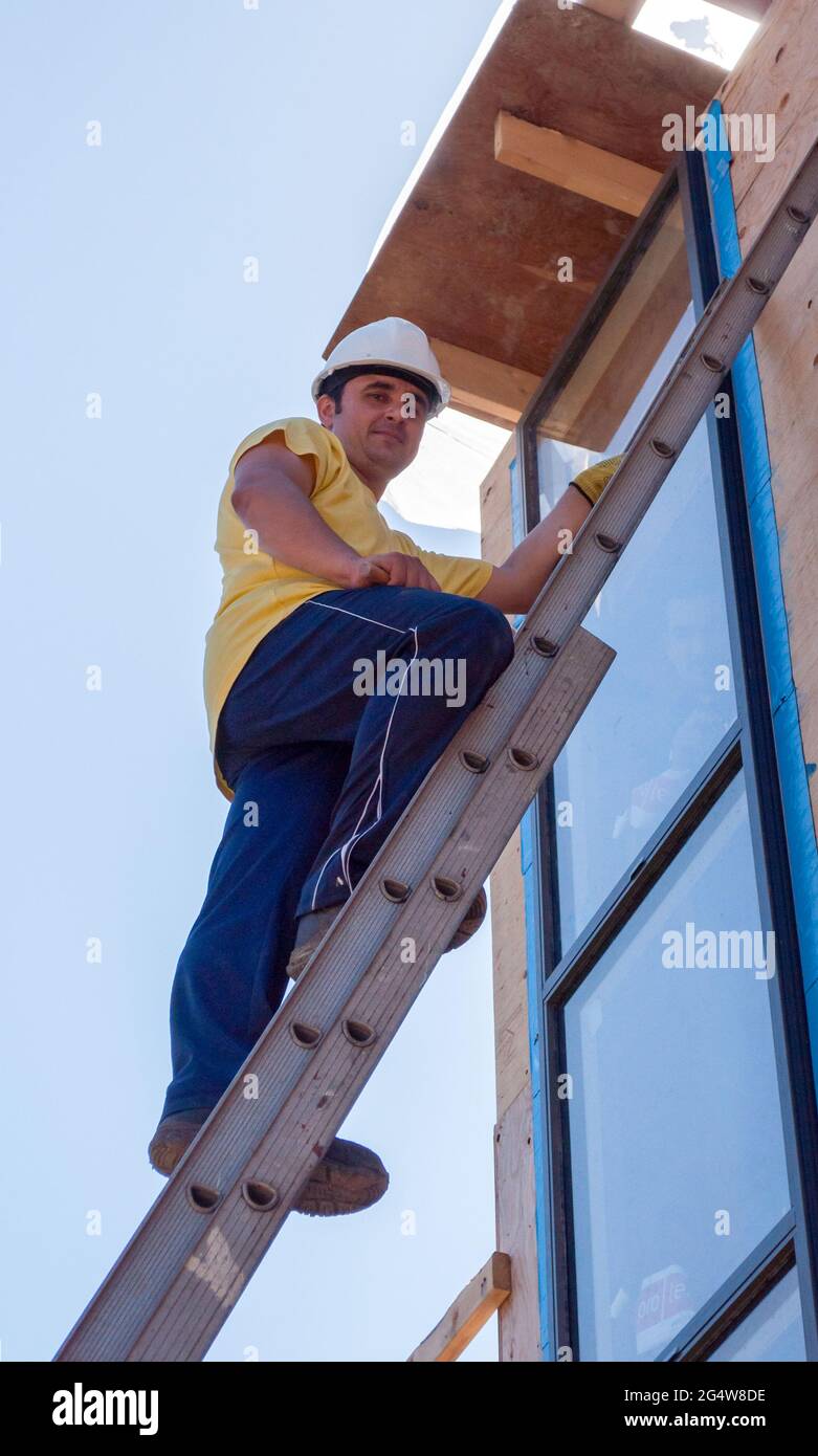 Construction workers working installing European style windows in a ...