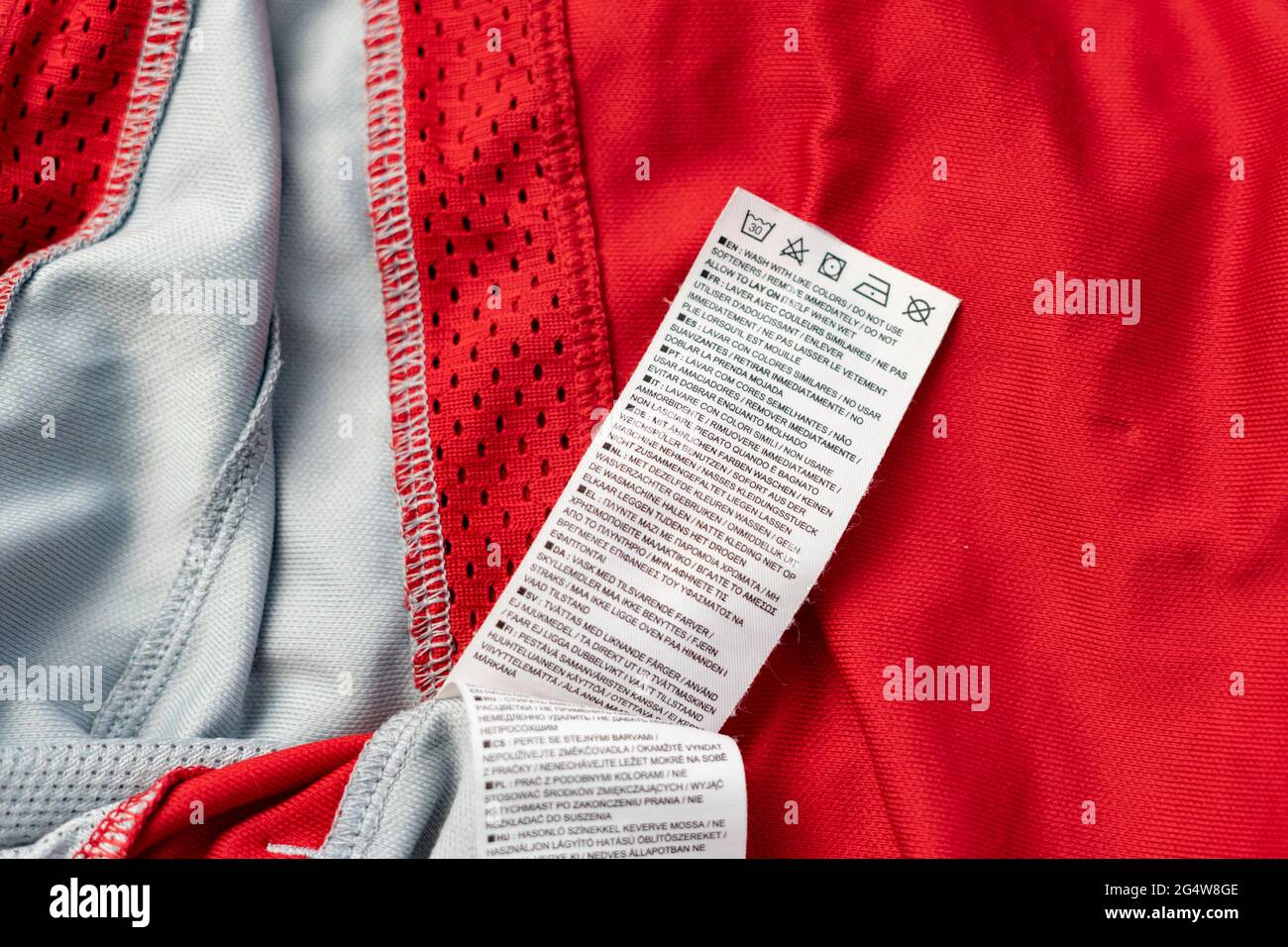 close up brand new clothes instruction before washing. laundry tag ...