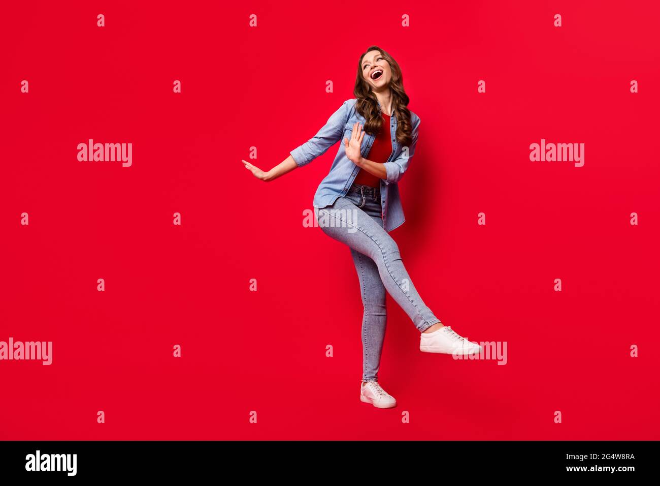 Photo of excited funny young lady dressed denim outfit walking dancing ...