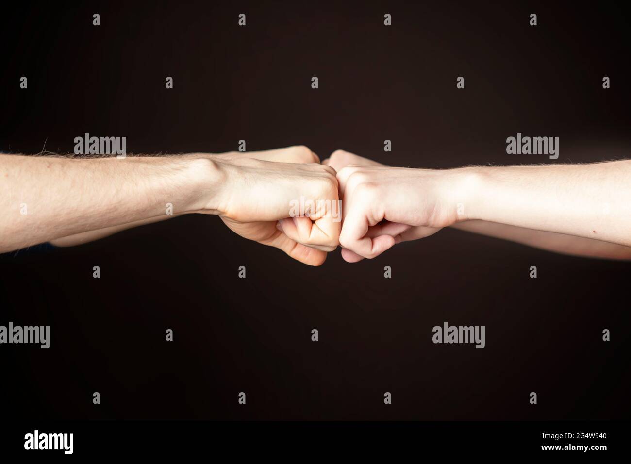 Fist bump or Knuckle bump between two friends Stock Photo - Alamy